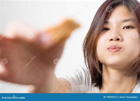 Cute Asian Girl Is Using Her Hand To Feed You A Piece Of Cake Stock