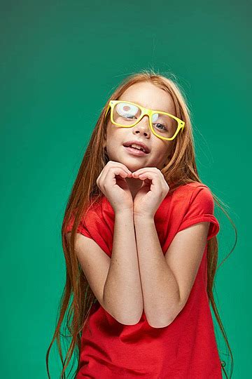 Adorable Young Girl With Red Hair And Glasses Making Hand Gestures On A