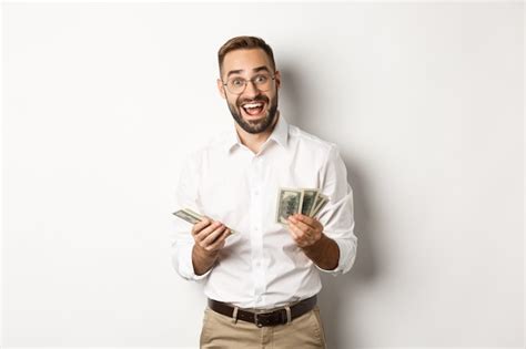 Free Photo Handsome Businessman Counting Money And Looking At Camera