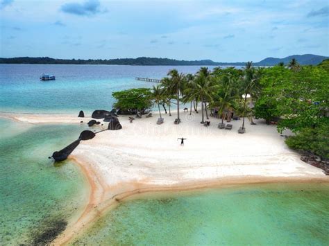 Idyllic Tropical Island With Lush Palm Trees And Pristine White Sand