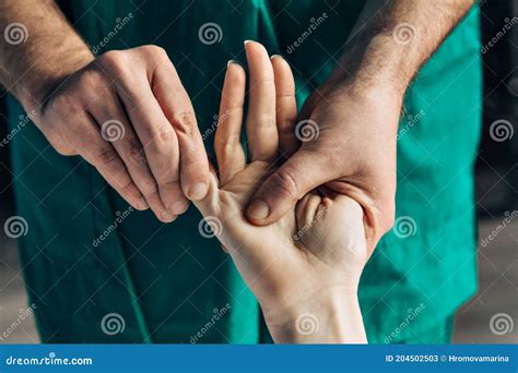 Wrist Massage A Male Massage Therapist Puts Pressure On A Sensitive