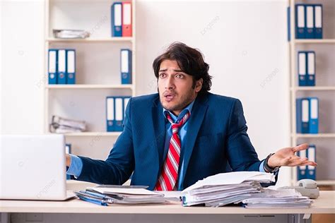 رجل أعمال شاب وسيم يجلس في المكتب المتجه الخلفية والصورة للتنزيل