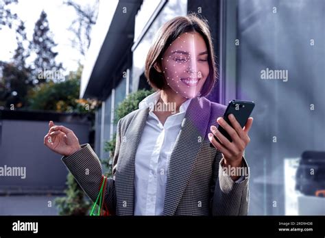 Woman Using Smartphone With Facial Recognition System On Street