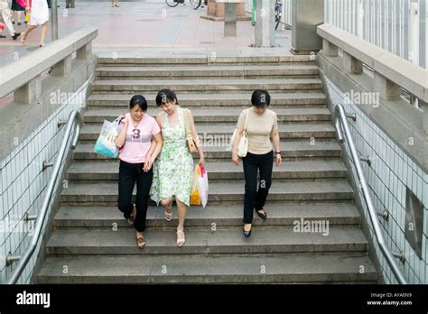 Asia China Beijing Chinese Women Walk Down Stairs Of Pedestrian