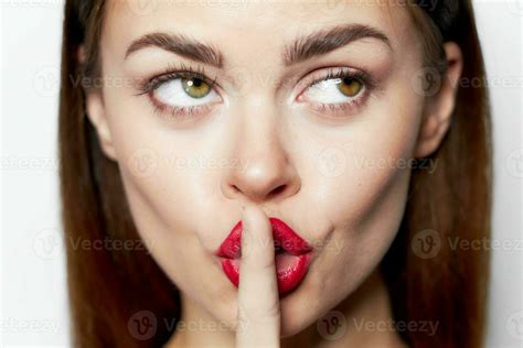 Portrait Of Woman Close Up Finger Near Red Lips Look Towards 23721406