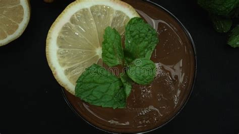 Tequila Sunrise Cocktail With A Slice Of Lemon And Fresh Mint Leave Comestible Stock Image