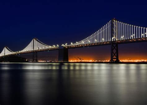 Premium Photo Illuminated San Franciscooakland Bay Bridge Over River