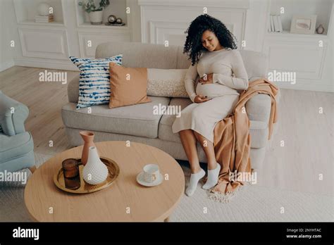 Beautiful Photo Of Pregnant Afro American Lady Sitting On Cozy Sofa