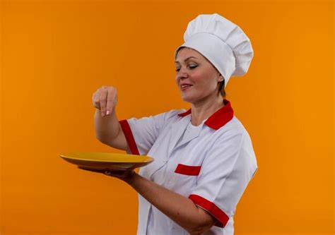 Free Photo Pleased Middle Aged Female Cook In Chef Uniform Looking