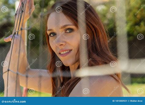 A Gorgeous Redhead Fitness Model Preparing To Play Volleyball Stock Image Image Of Adult