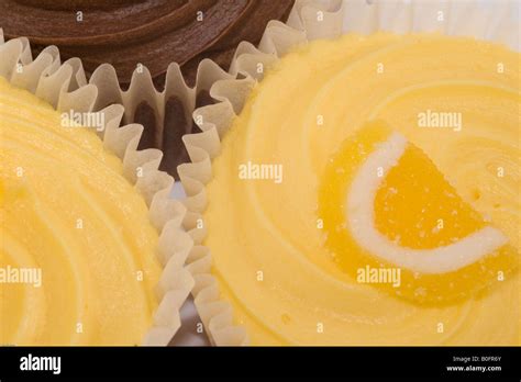 Lemon Buns With Butter Icing And Sugared Lemon And A Chocolate Bun