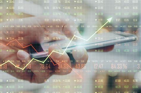 Premium Photo Trading Concept With Man Using Mobile Phone And Business Chart Screen