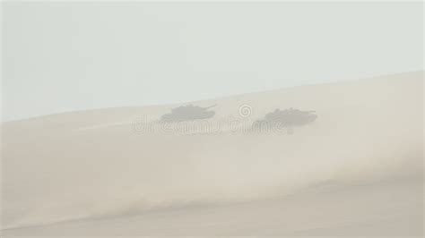 Fast Military Tanks Moving On Desert Dunes And Creating A Dusty Path