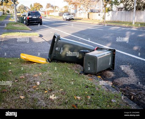 View Of Rubbish Wheelie Bins Toppled By Strong Wind Laying On Ground