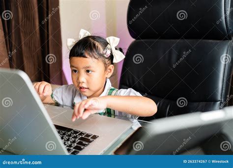 Closeup Of A Cute Southeast Asian Girl Sitting In Front Of A Laptop