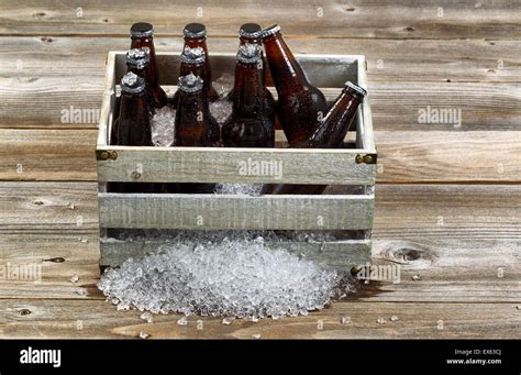 Vintage Crate Filled With Bottled Beer And Crushed Ice On Rustic Wooden