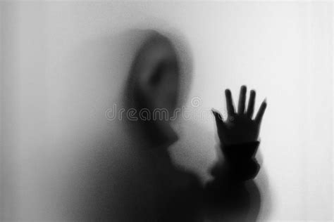 Shadow Blur Of Horror Man In Screaming Mask And Hand Touches The Stock