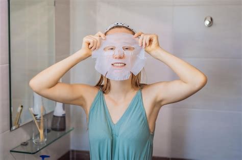 Premium Photo Young Redhaired Woman Doing Facial Mask Sheet Beauty