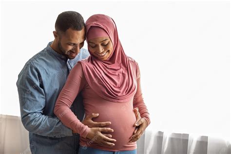 Premium Photo Black Husband Hugging Pregnant Muslim Wife While