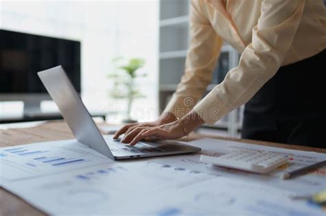 Woman Meticulously Plans A Finance Audit Using A Computer And Calculator To Review Budget