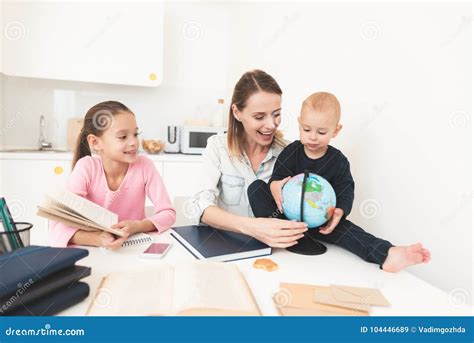 Mom Helps My Daughter Do Her Homework In The Kitchen Stock Image