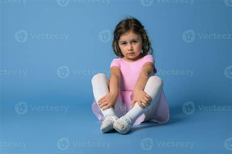 Focused Girl Ballerina Stretching Her Legs Before Workout On Ballet