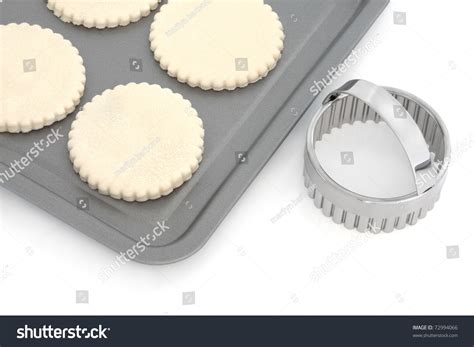 Pastry Biscuit Dough On A Baking Tray With Cookie Cutter Over White