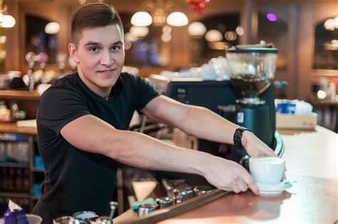 Junges Barista Das Kamera Betrachtet Kostenlose Foto