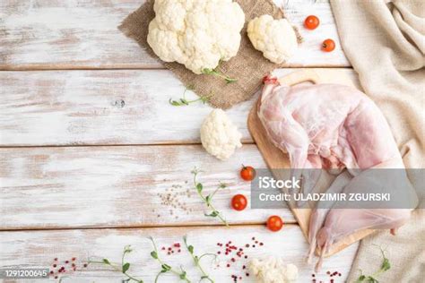 흰색 나무 배경과 린넨 직물에 콜리플라워 토마토와 향신료와 전체 원시 토끼 상단 보기 플랫 레이 복사 공간 0명에 대한 스톡