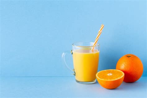 Premium Photo Glass With Orange Juice And Oranges