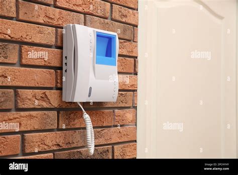 Modern Intercom System With Handset On Red Brick Wall Indoors Space