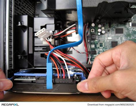 hands installing computer parts stock images by megapixl