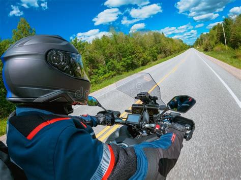 POV Side View Biker Riding Motorcycle Against Blue Sky Green Trees