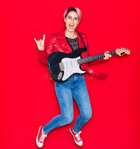 Young Beautiful Guitarist Woman With Pink Short Hair Playing Electric