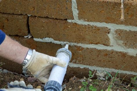 Premium Photo A Person Using A Drill To Remove Bricks From A Brick Wall