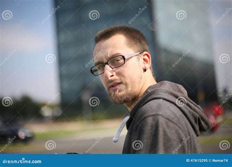 A Young Man With Eyeglasses Walking On The Street Stock Image Image