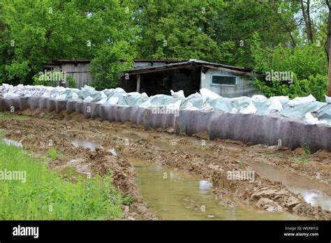 Temporary Flood Protection Wall Made Of Box Barriers And Sandbags Covered With Thick Geotextile