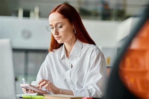 A Redhead Female Tutor Engages In Stock Image Image Of Educational Desk