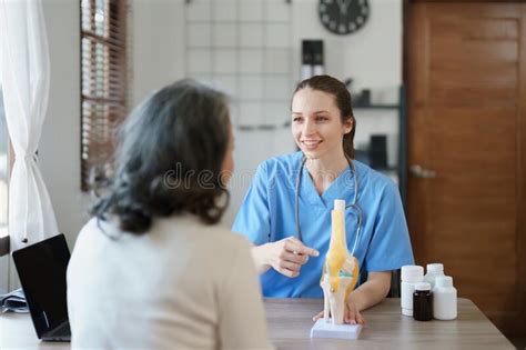 Portrait Of A Female Doctor Talking To An Elderly Patient About