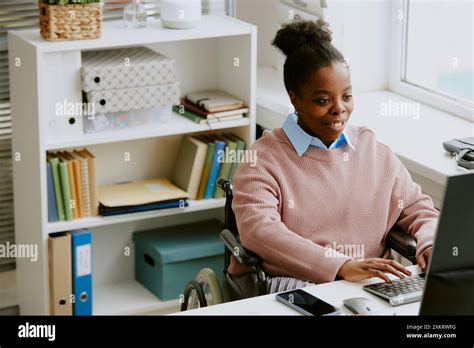 Young African American Female Programmer With Disability Enjoying Coding In Cozy Light Office Of