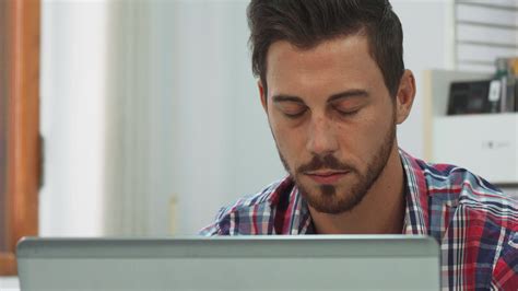 A Serious Guy Type Something On The Keyboard On The Computer 35290594