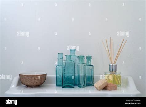 a collection of restful objects displayed on a clean white toilet