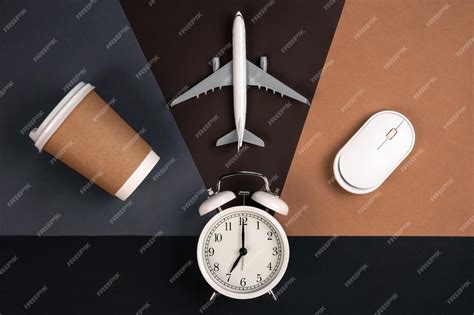 free photo alarm clock computer mouse cup and airplane on a paper