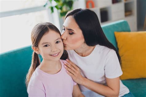 Photo Of Adorable Mother Kiss Her Daughter Spending Time Together