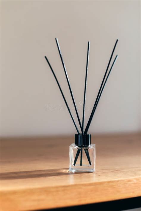 Aroma Diffuser In A Clear Glass Bottle With Black Cap On Wooden Table
