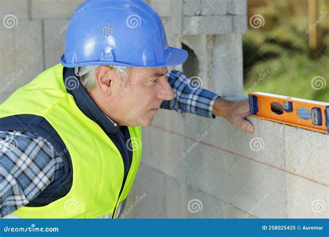 Male Worker Fixing Wall At Construction Site Stock Image Image Of