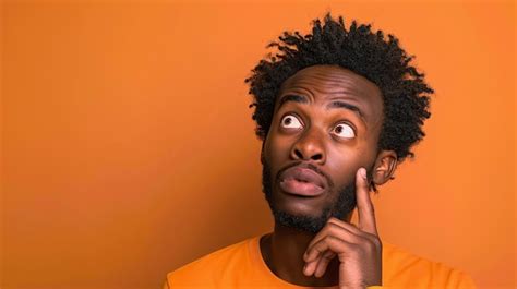 Premium Photo African American Male With Puzzled Expression On Orange