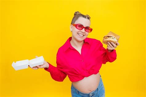 Premium Photo Hungry Pregnant Woman Holding Hamburger Eating Junk