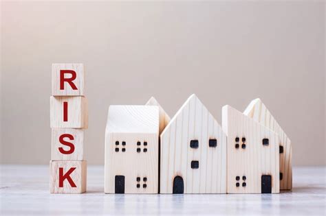 Premium Photo Risk Cube Blocks With Wooden House Model On Table