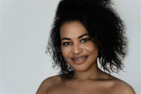 Portrait Of Smiling Black Woman With Dental Braces On Her Teeth Stock